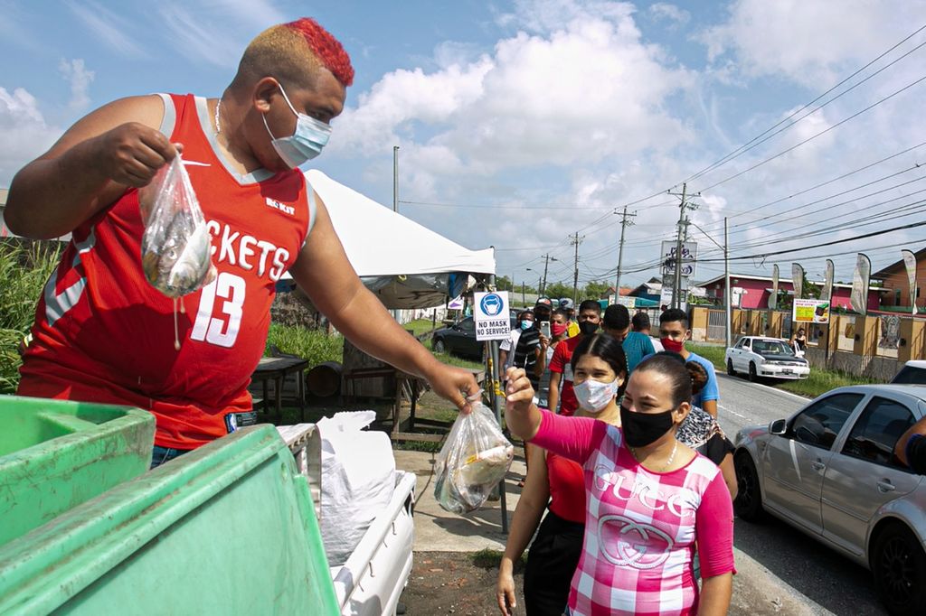Venezuelan national gives away free fish - Trinidad Guardian